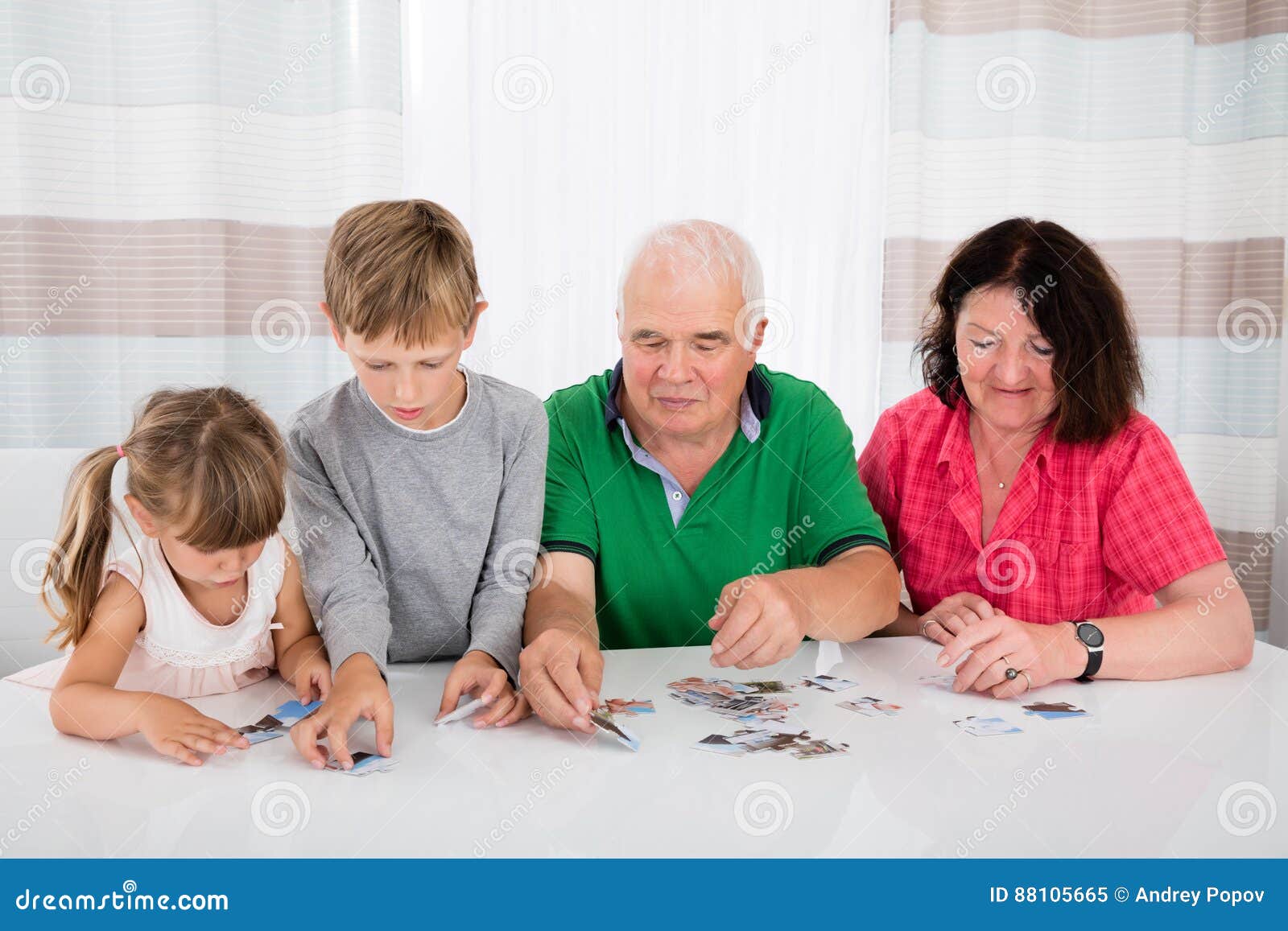 Multi Generation Family Solving Puzzle Together Stock Image - Image of ...
