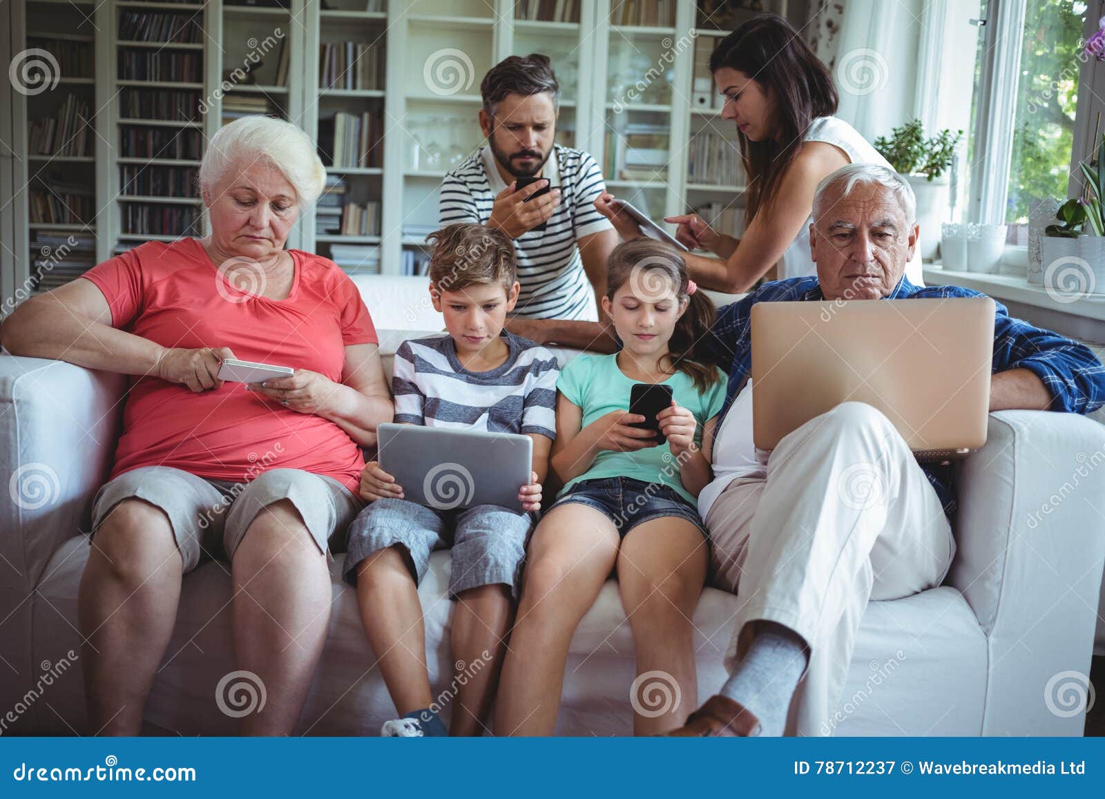 Multi-generation Family Using Laptop, Mobile Phone and Digital Tablet ...