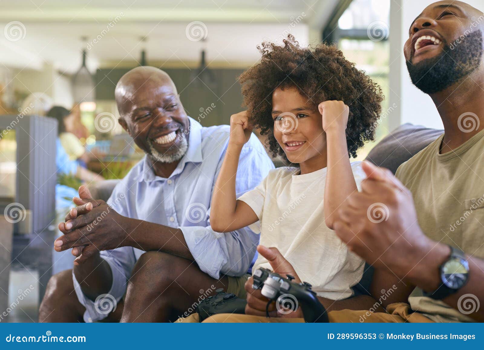 Multi-Generation Male Family Having Fun Playing Computer Game at Home ...