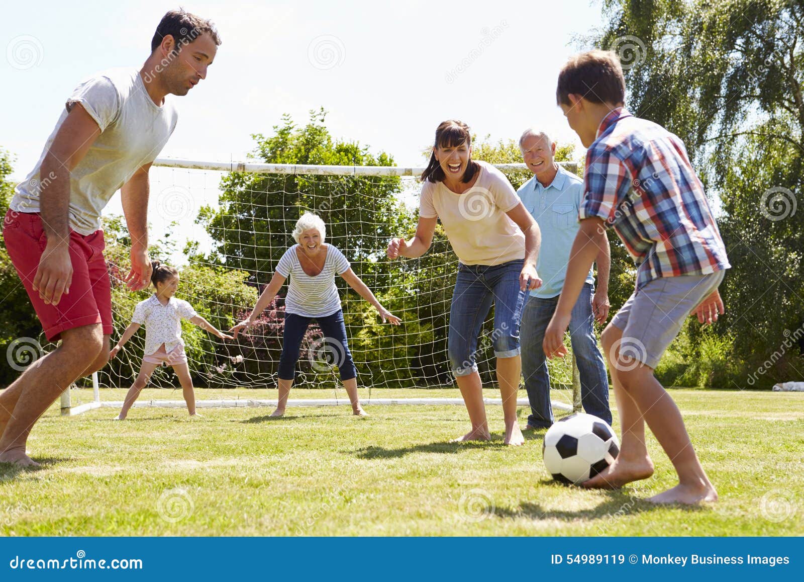 Multi Generation Playing Football in Garden Together Stock Image ...