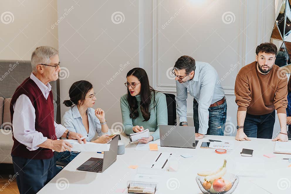 Multiethnic Team of Business Professionals Engaged in a Collaborative ...