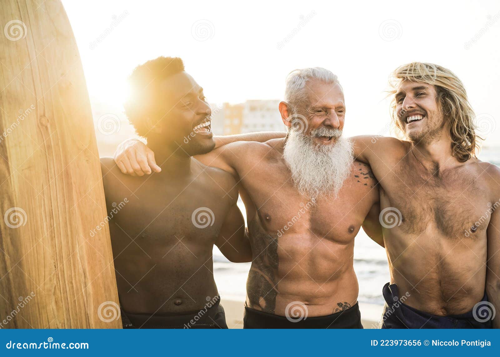 Multi Generational Surfer Friends Having Fun on the Beach after Surf ...