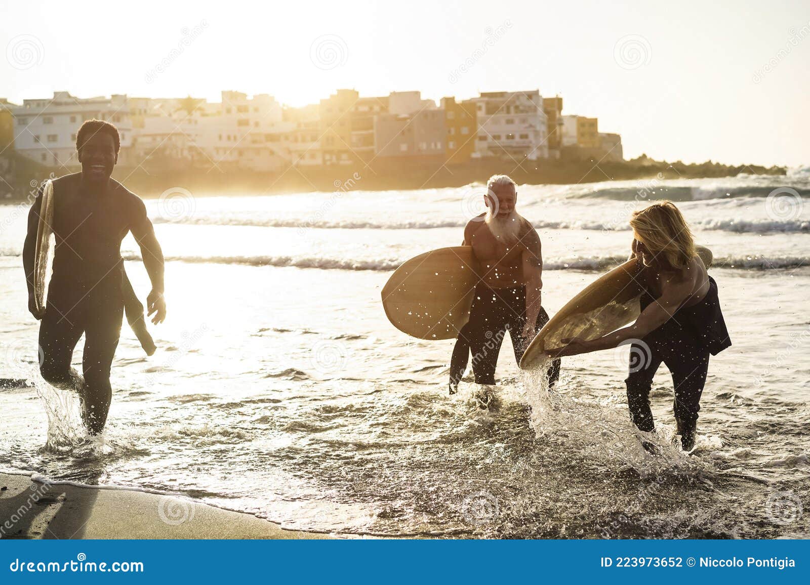 Multi Generational Surfer Friends Having Fun while Surfing on Beach ...