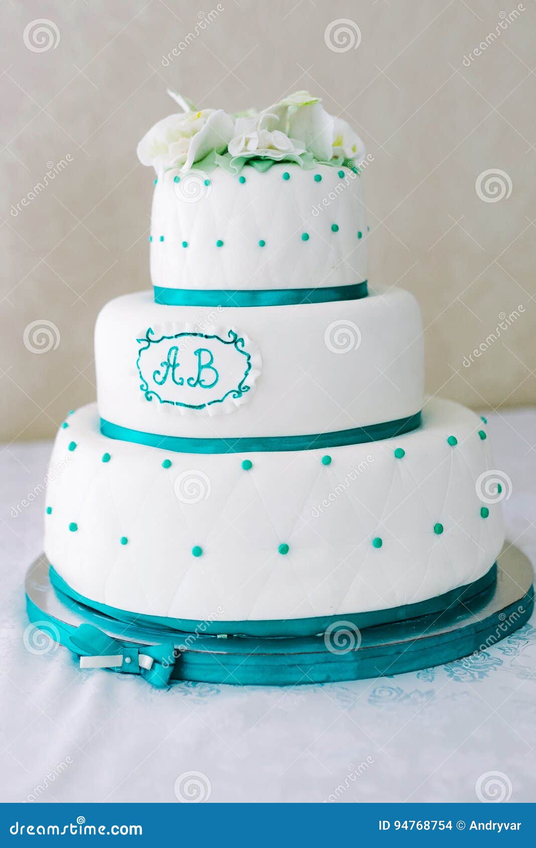 Multi-level White Wedding Cake and Beige Flowers on Top Stock Photo ...