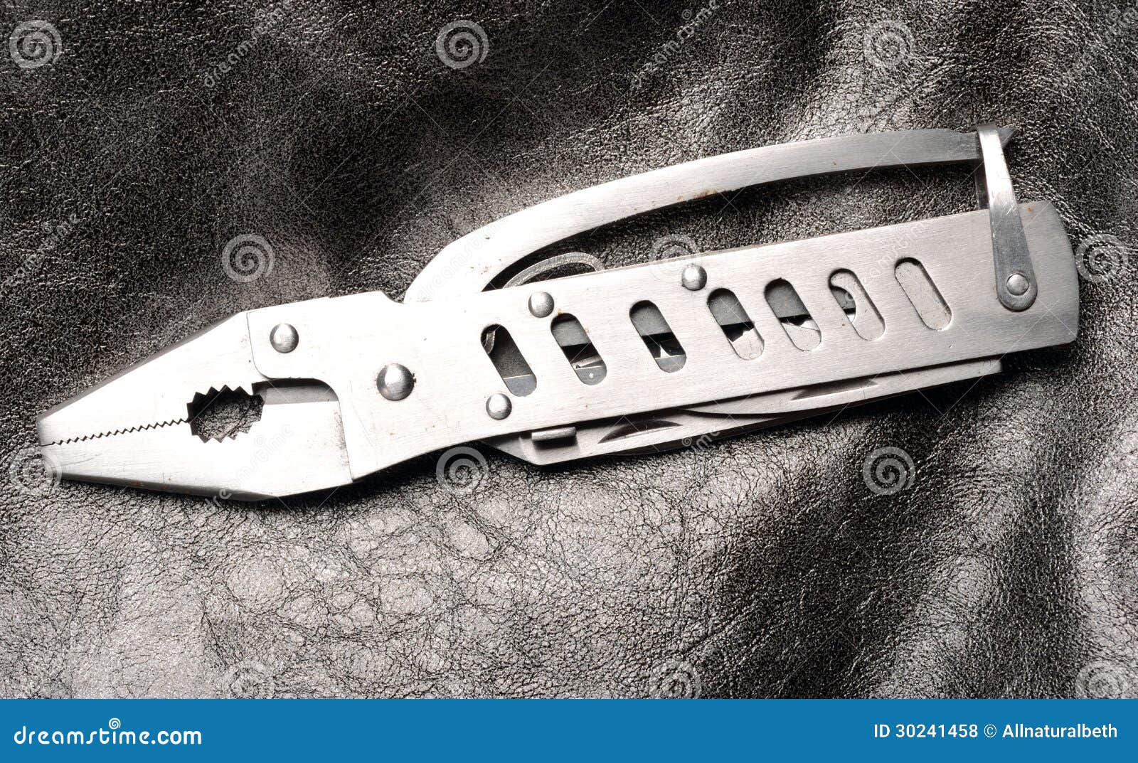 Multi-purpose tool on gray stock photo. Image of tool - 30241458