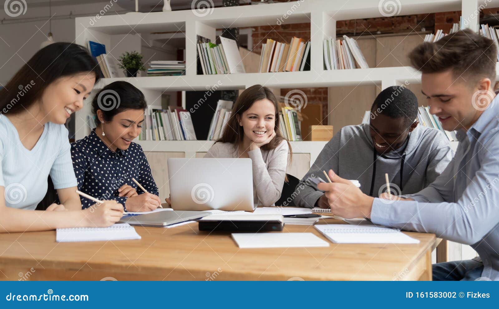 Multi-racial Students Study Together Seated at Library Desk Stock Photo ...