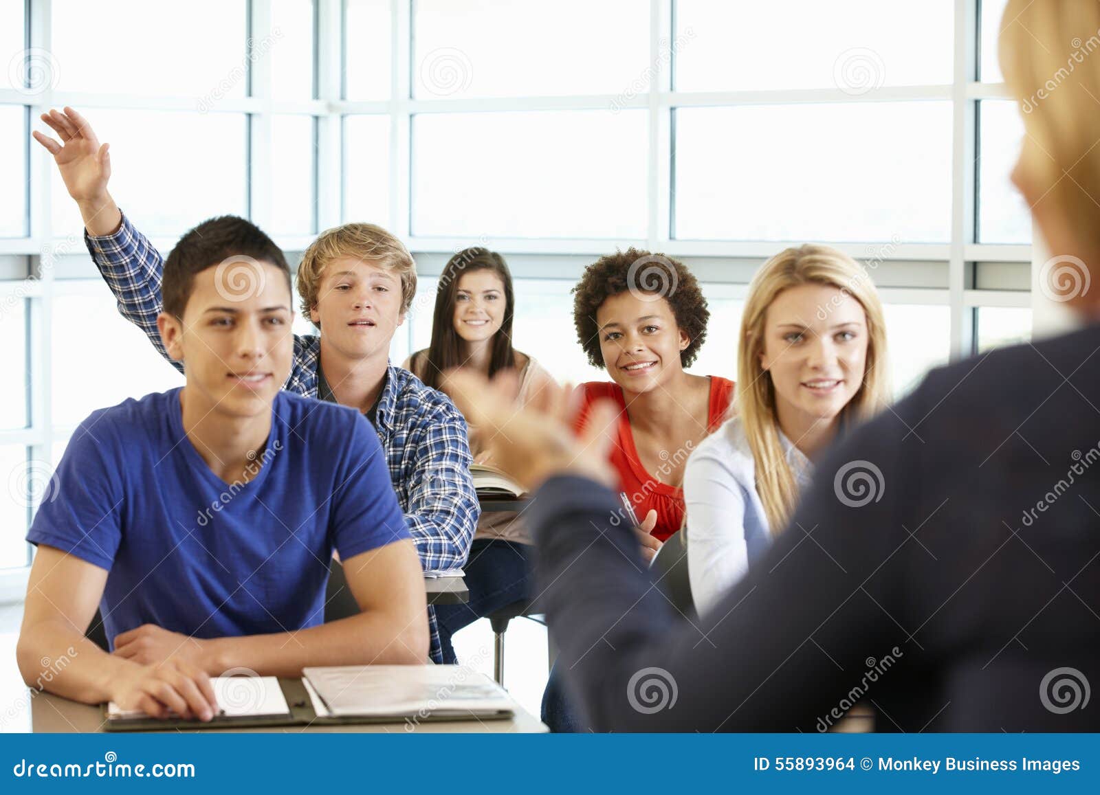 Multi Racial Teenage Pupils in Class One with Hand Up Stock Photo ...