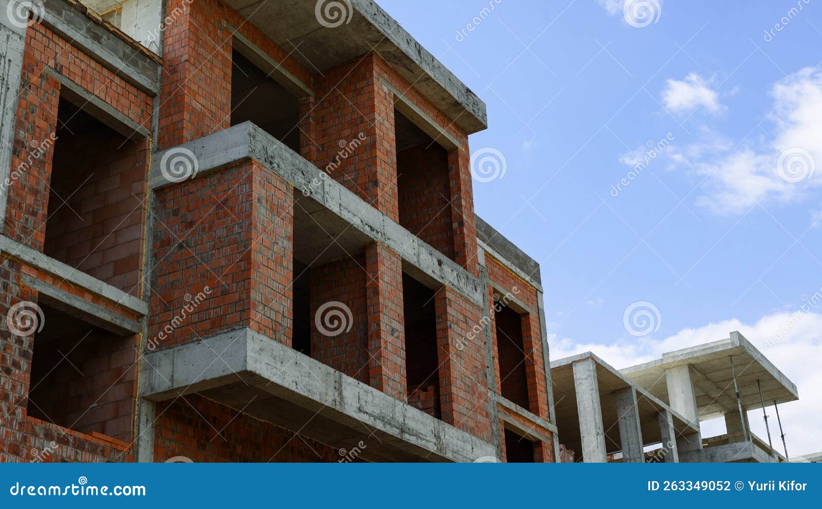 A Multi-storey Building Made of Monolithic and Red Brick Stock Photo ...