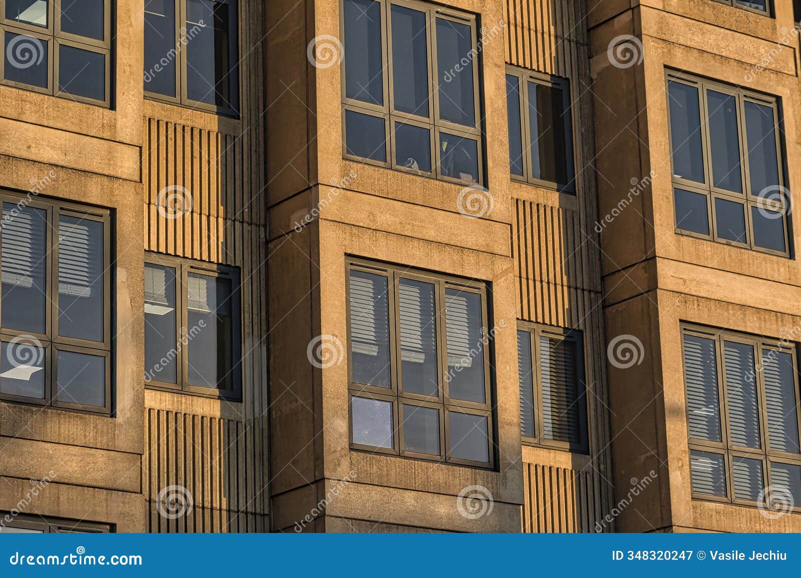 Multi-Window Facade of Tan Building with Vertical Detailing Stock Image ...