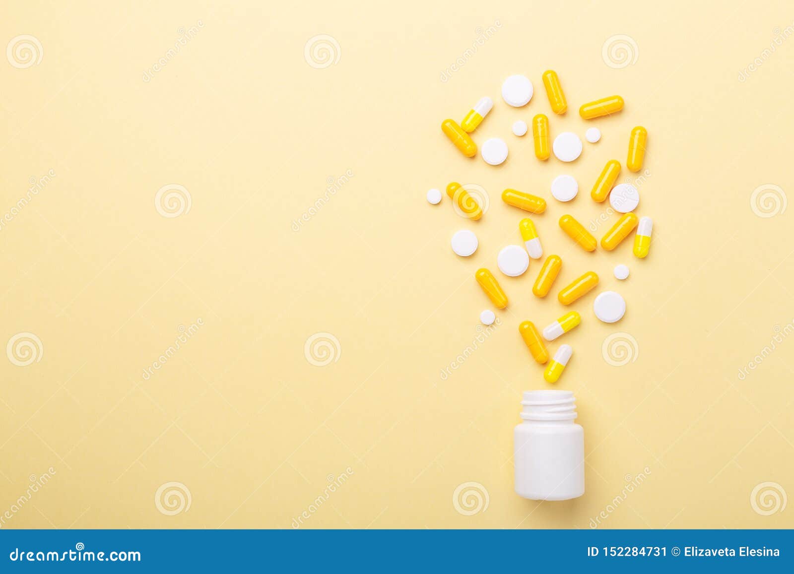 Multicolor Tablets and Pills Capsules from Plastic Bottle on Yellow ...