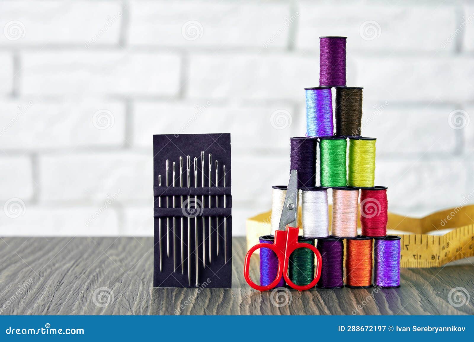 Multicolor Threads Bobbins Placed As Pyramid with Scissors and Needles ...