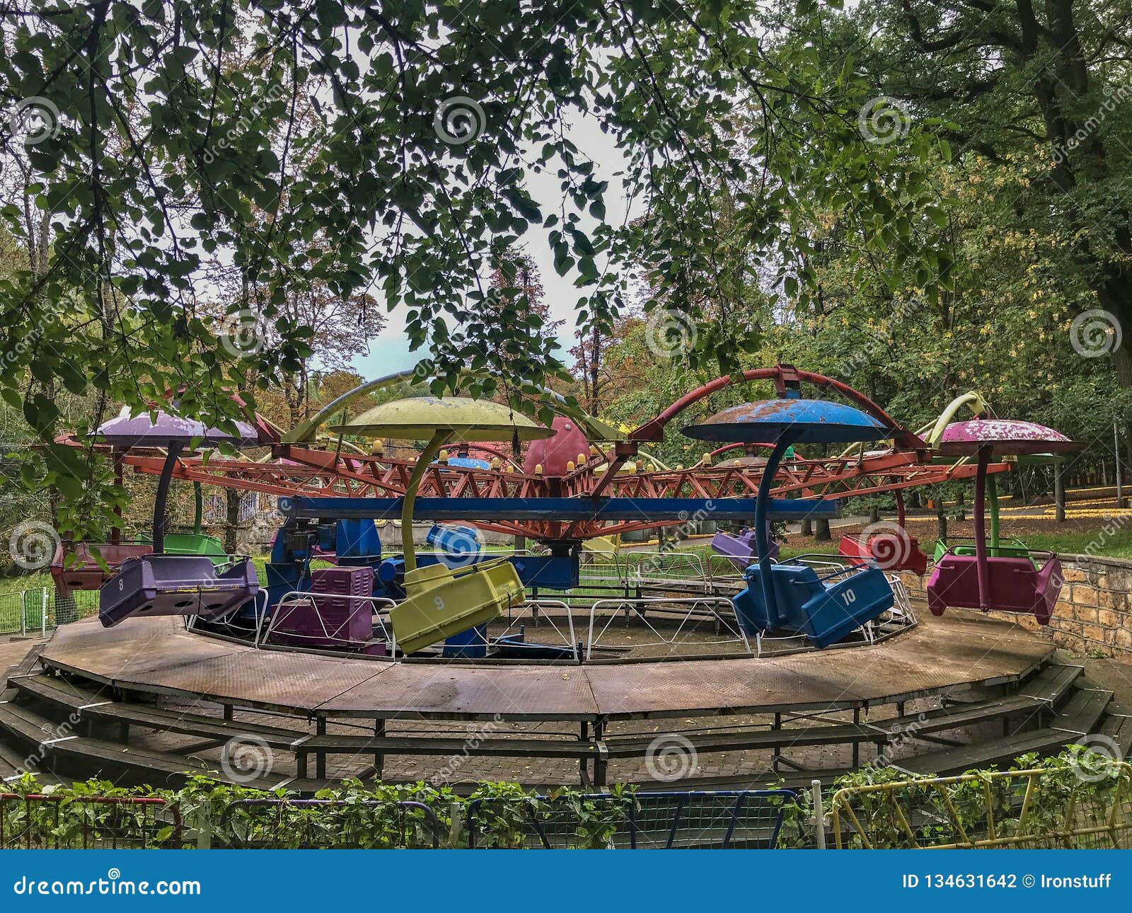 Carousel at amusement park stock photo. Image of foliage - 134631642