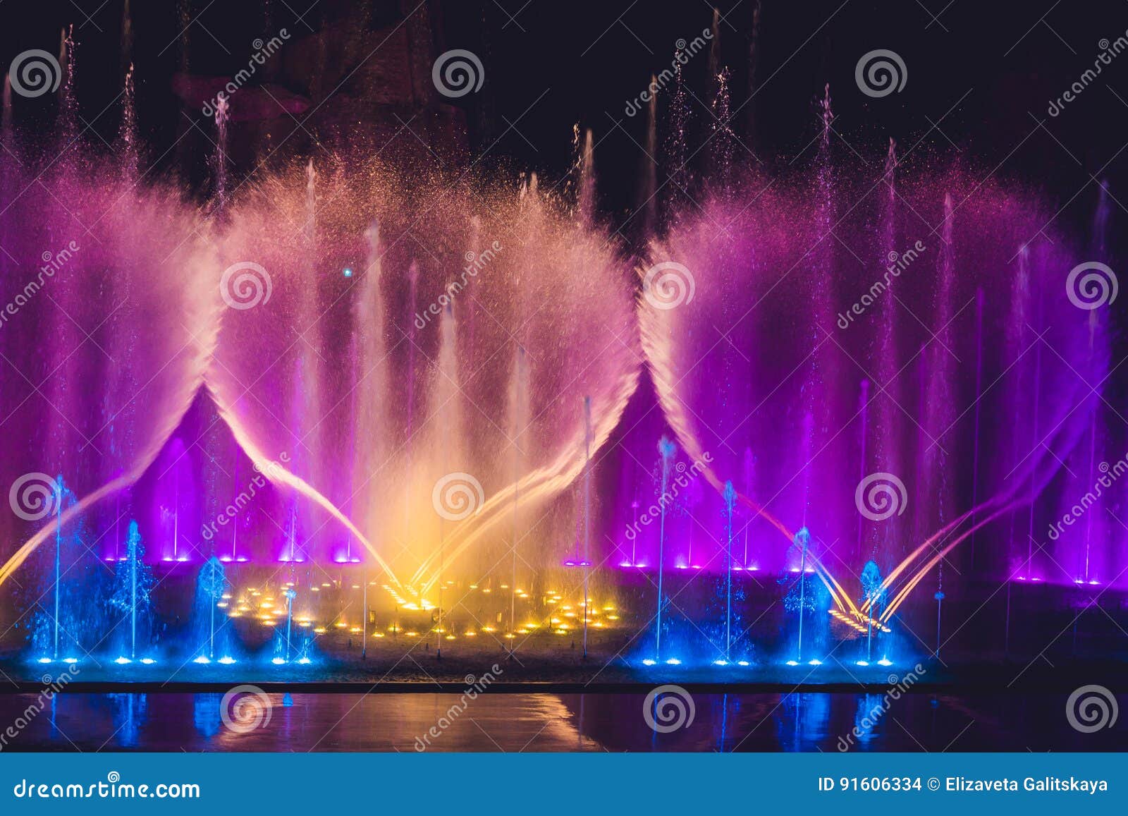 Multicolored Dancing Water Jet Fountain in the Dark Stock Photo - Image ...
