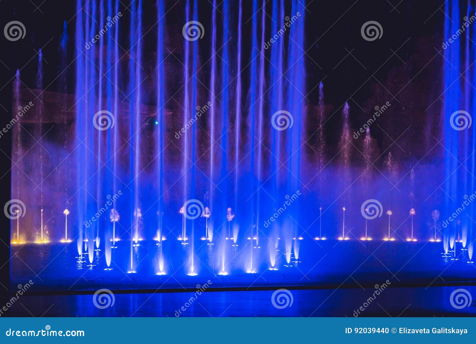 Multicolored Dancing Water Jet Fountain in the Dark Stock Photo - Image ...
