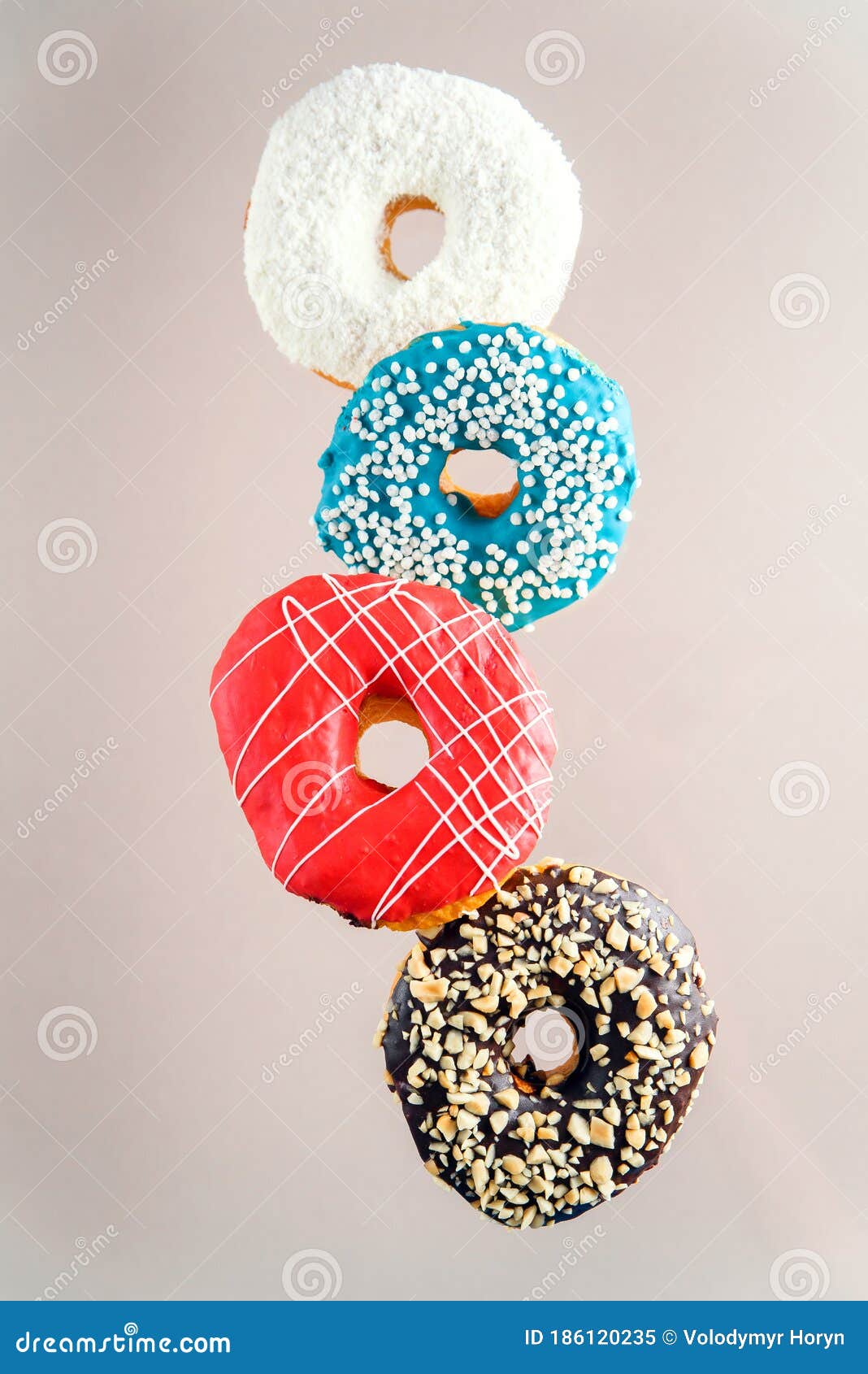 Multicolored Decorated Doughnuts in Motion Falling on Brown Background ...
