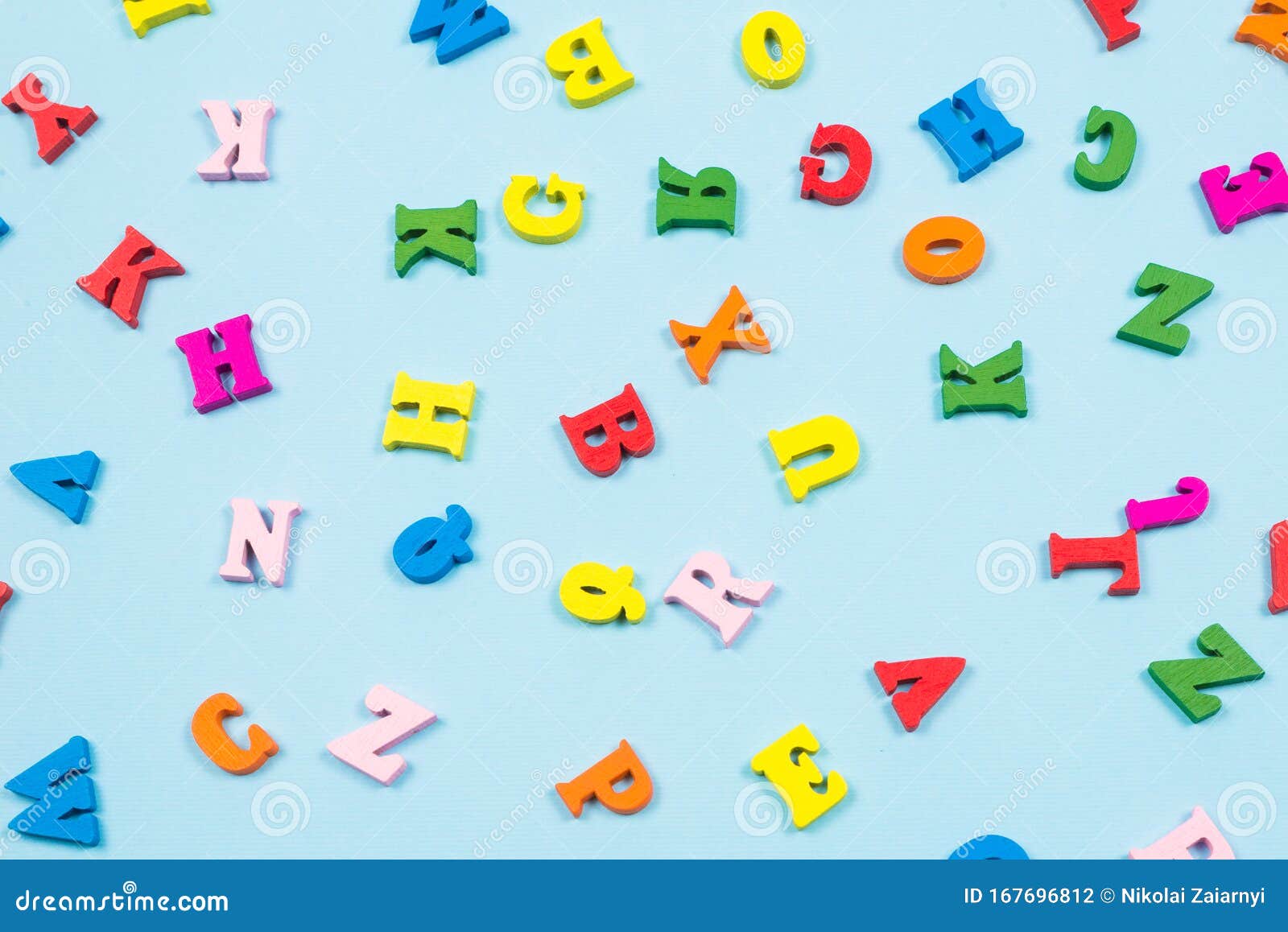 Multicolored Letters on a Blue Background Stock Photo - Image of board ...