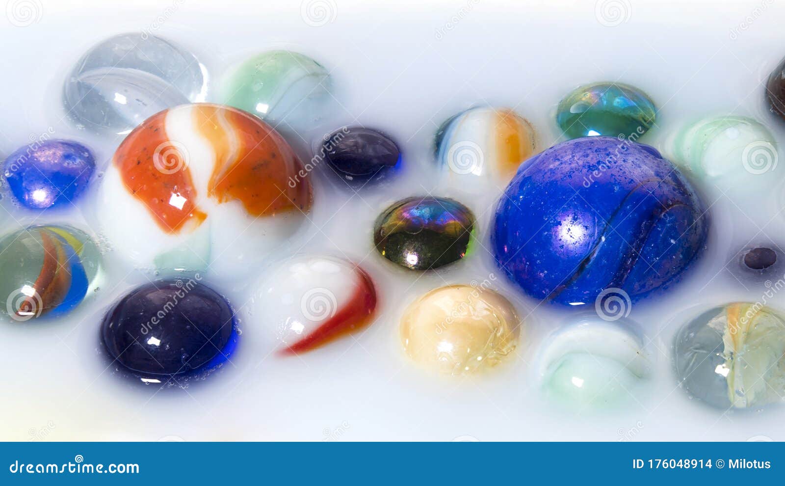Multicolored Marbles Inside Milk As Background Stock Photo - Image of ...