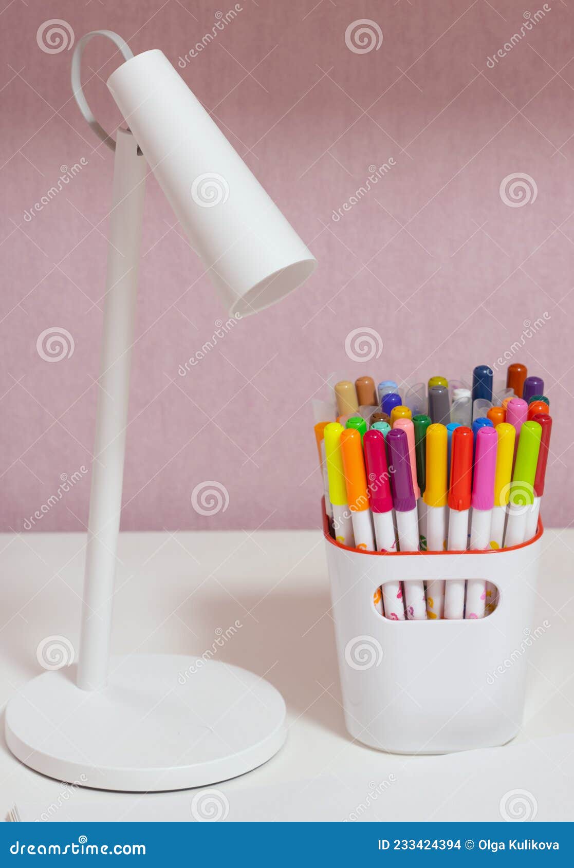 Multicolored Markers in a White Container and White Table Lamp Stock ...