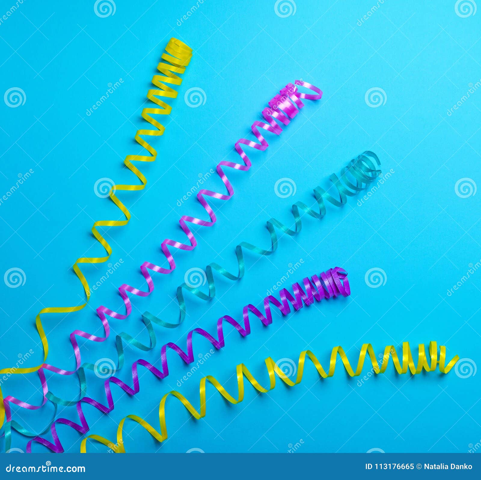 Multicolored Paper Serpentine Stretched Over a Blue Background Stock ...