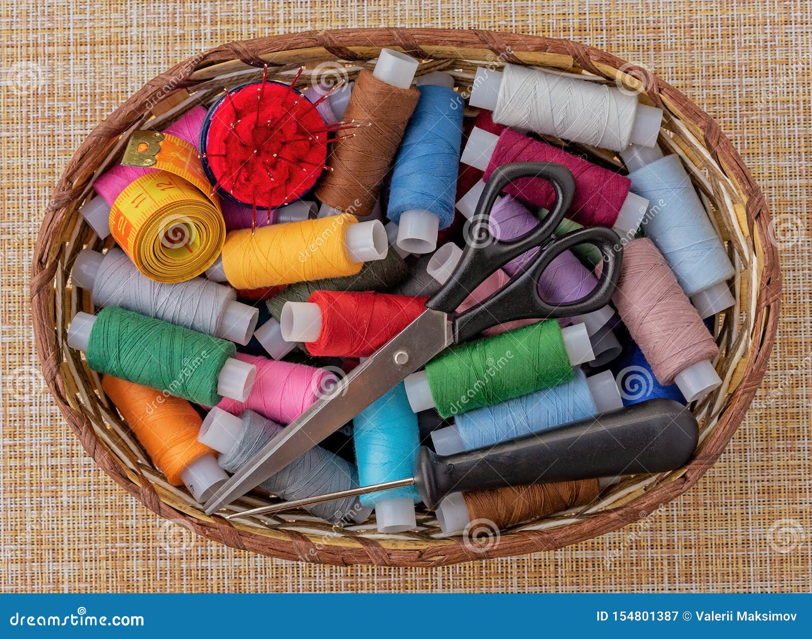 Multicolored Sewing Threads in a Wicker Basket. Spools of Thread for ...