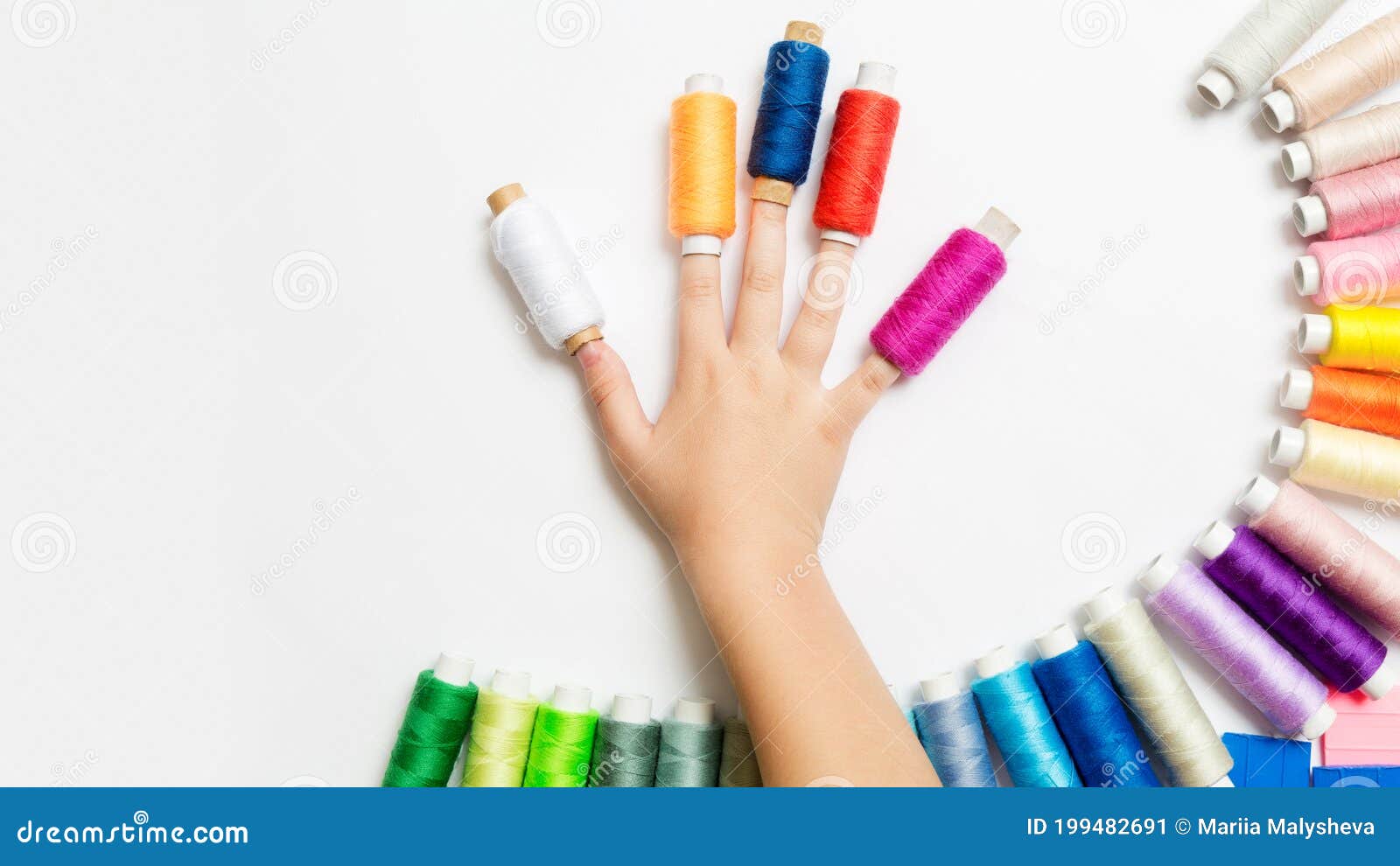 Multicolored Small Spools of Thread on the Fingers on the White ...