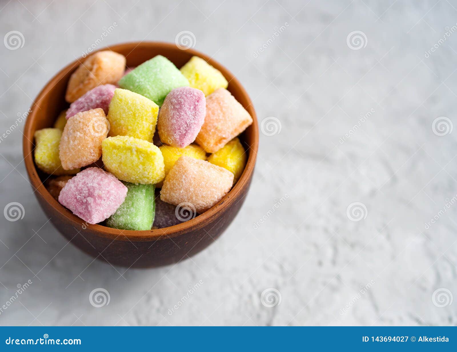 Multicolored Sweets Candy Pads in a Clay Cup , on a Blue Textured ...