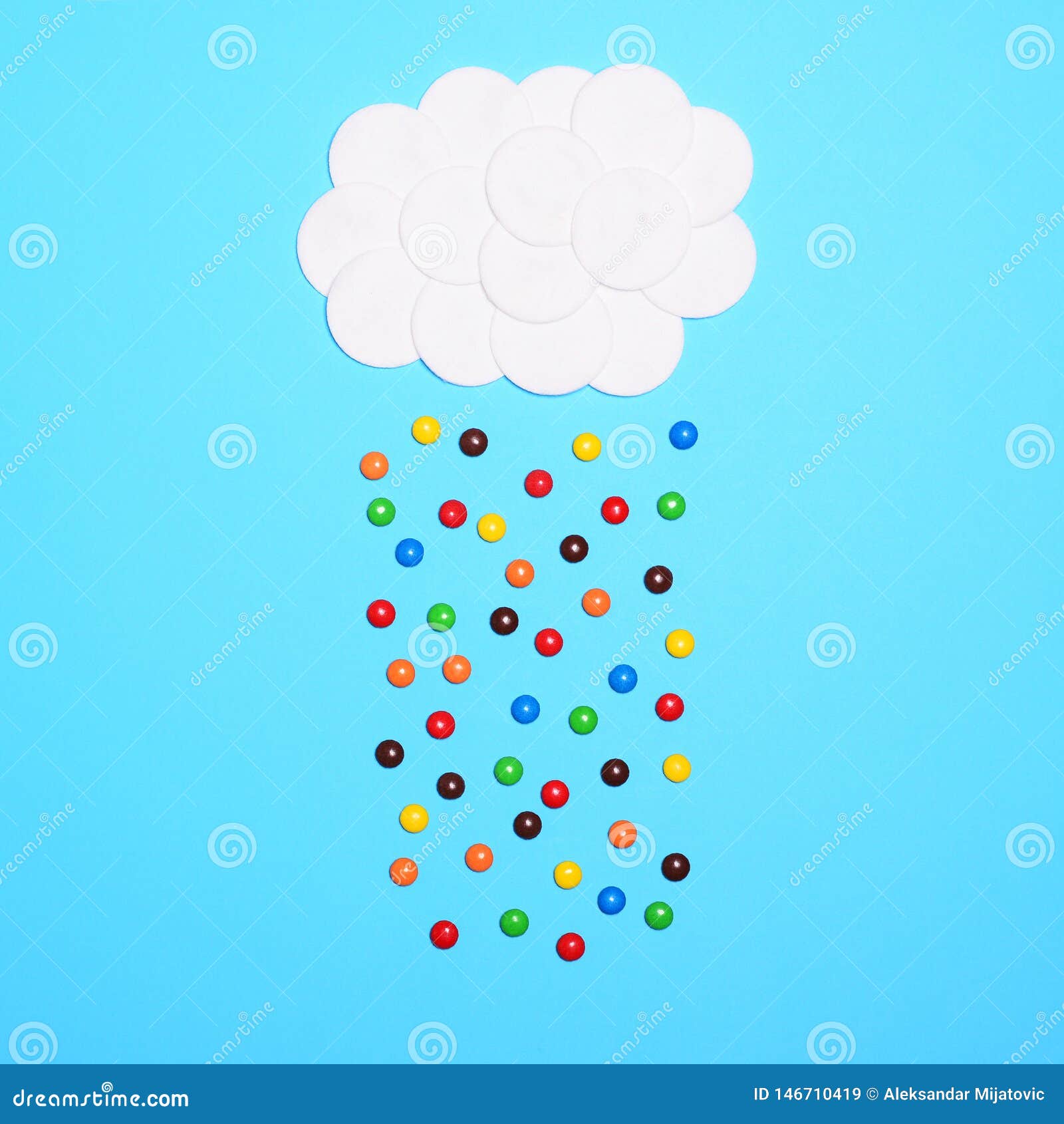 Multicolored Sweets Falling from Cotton Clouds Against Blue Background ...