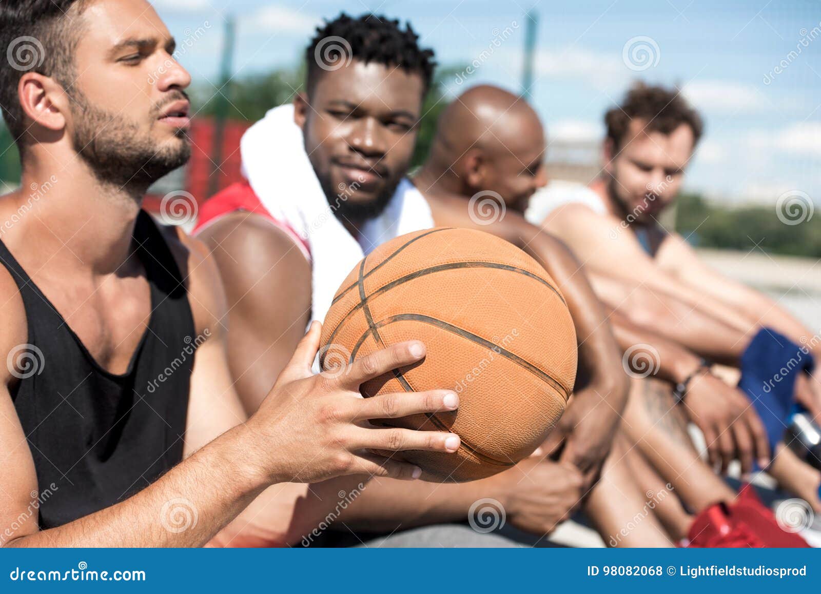 Multicultural Basketball Team Resting after Game on Court Stock Photo ...