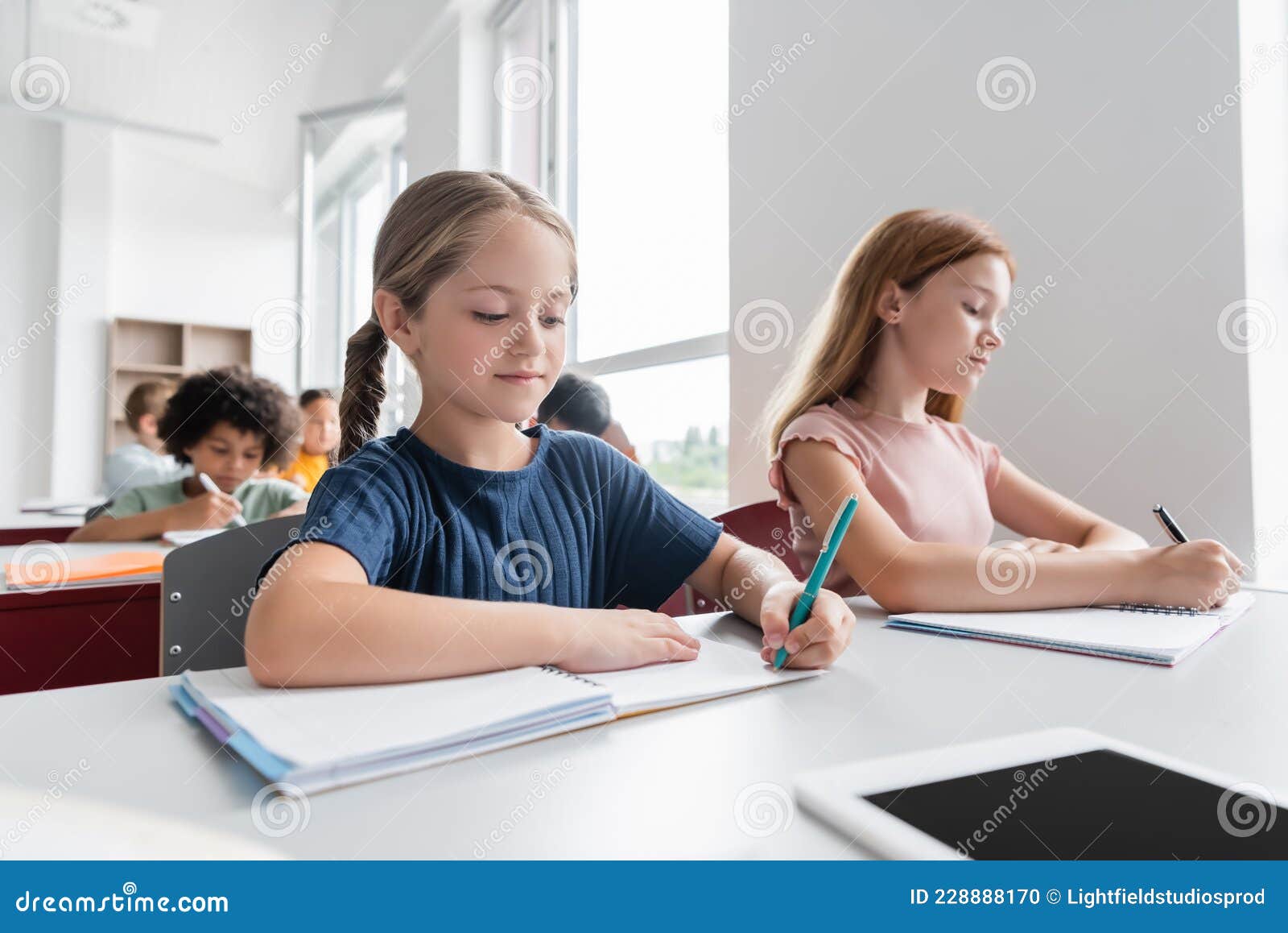 Multicultural Children Writing in Notebooks during Stock Photo - Image ...