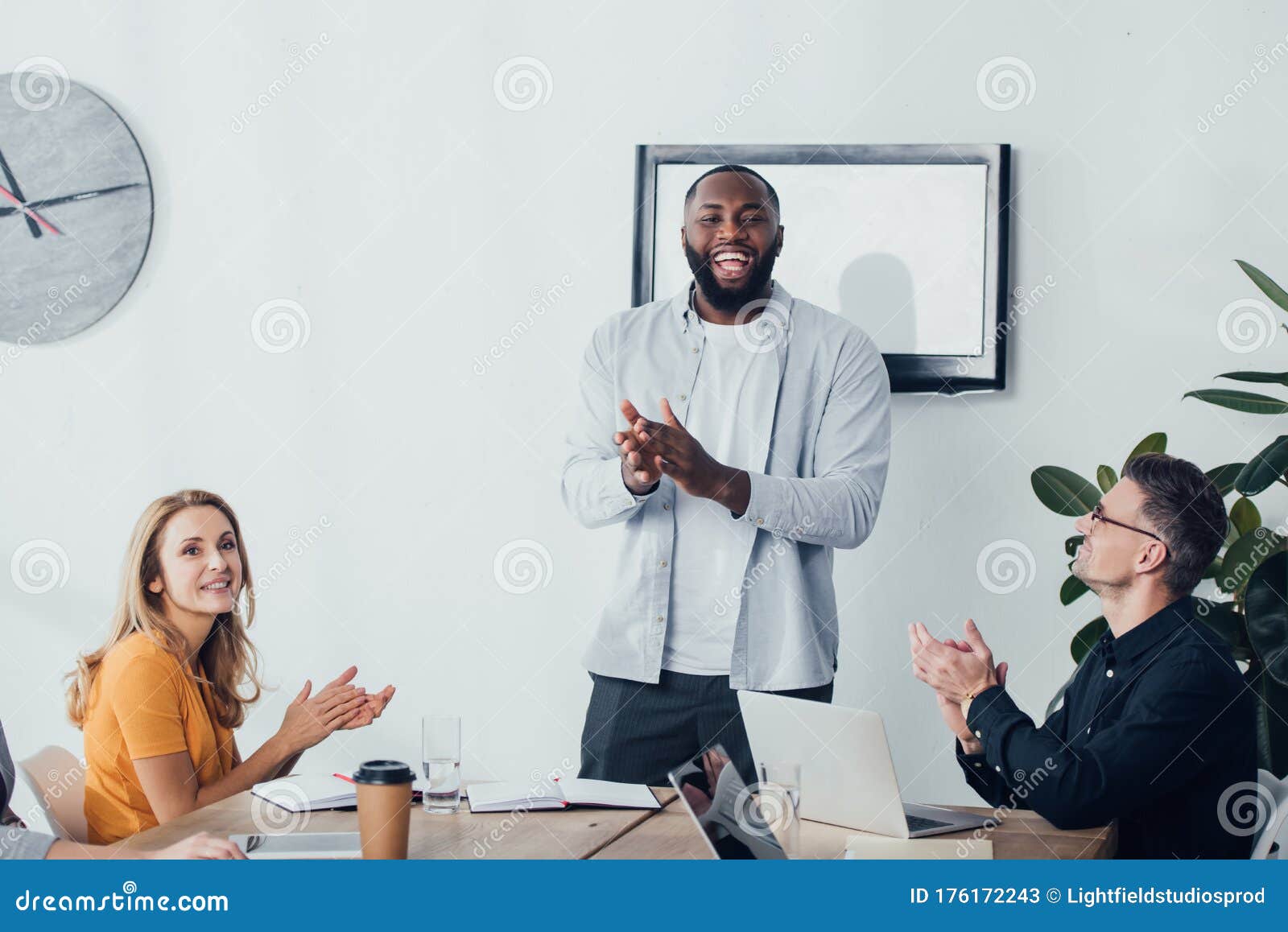 Multicultural Colleagues Clapping and Looking at Stock Image - Image of ...