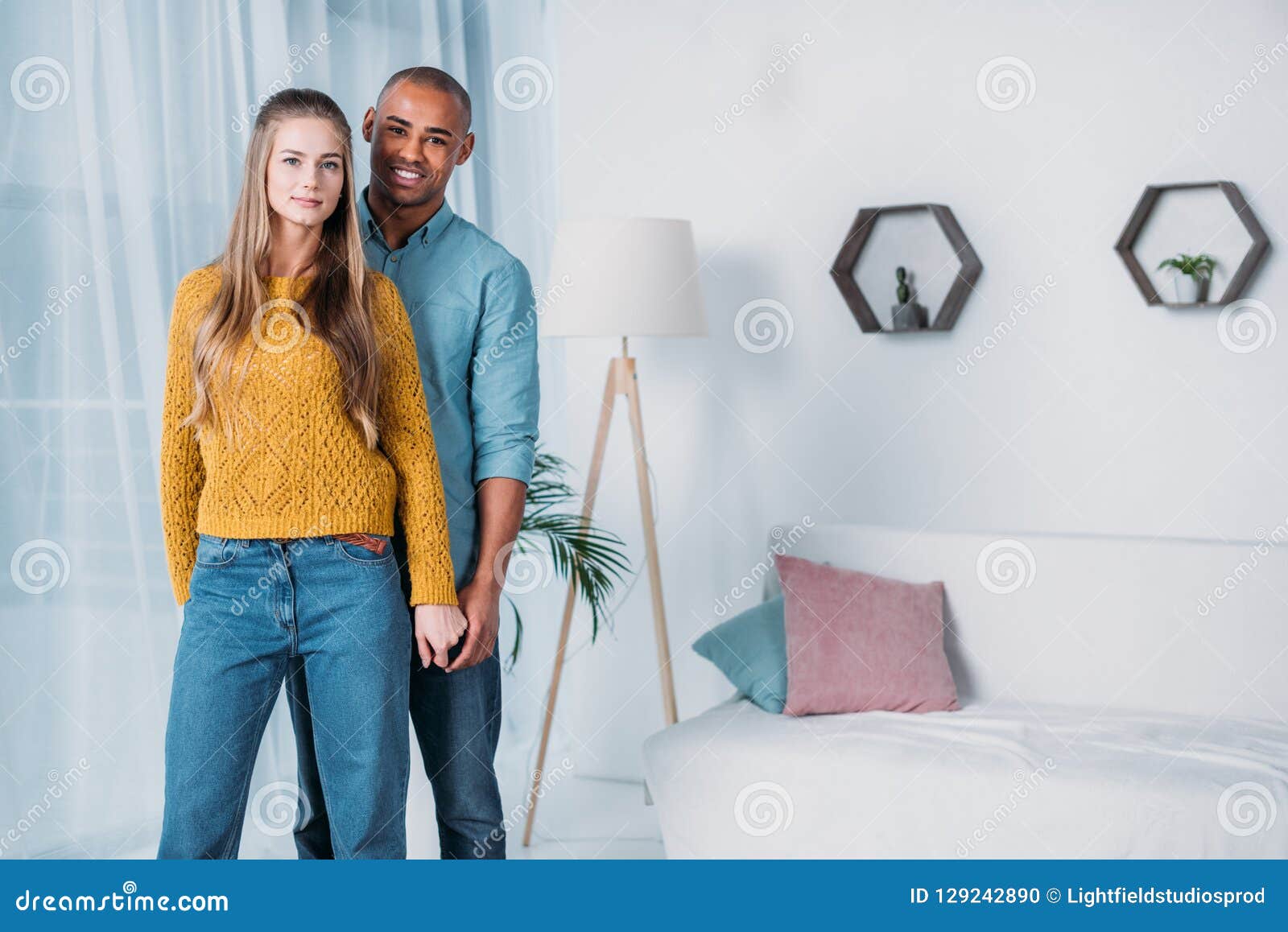 Multicultural Couple Holding Hands and Looking Stock Photo - Image of ...