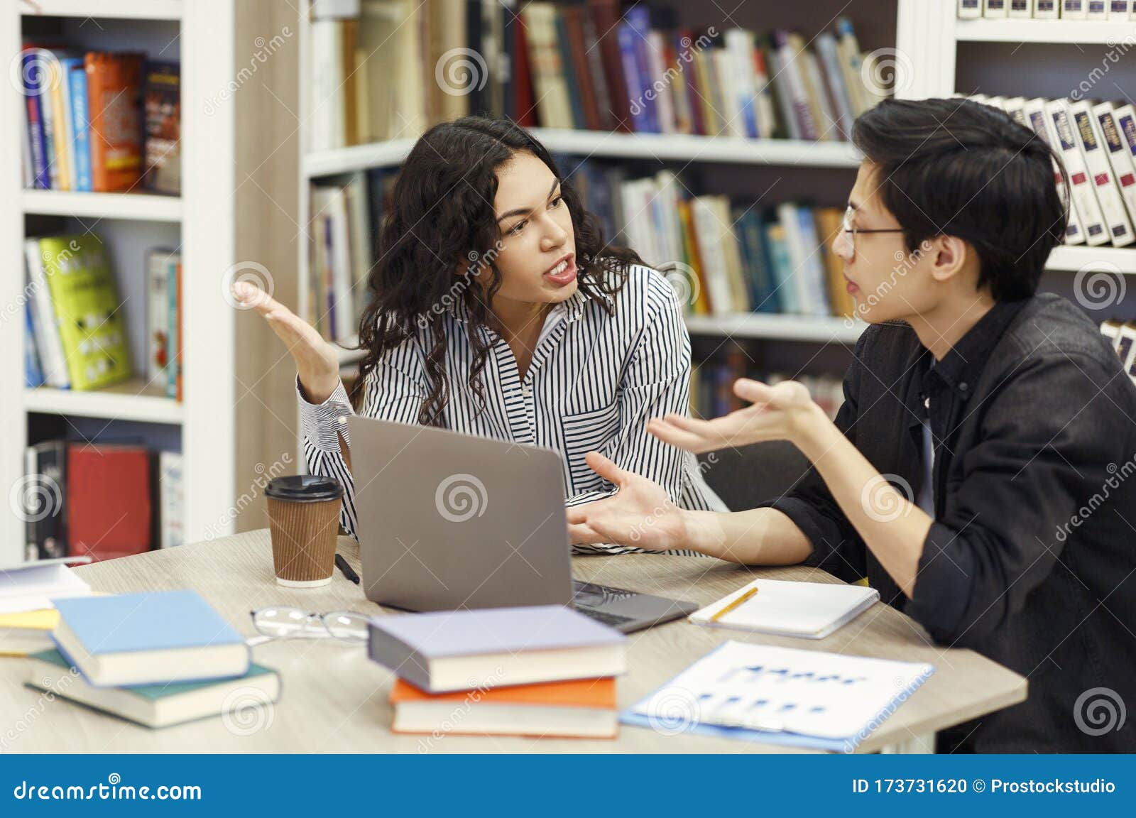 Multicultural Couple Sharing Ideas about Coursework in Library Stock ...