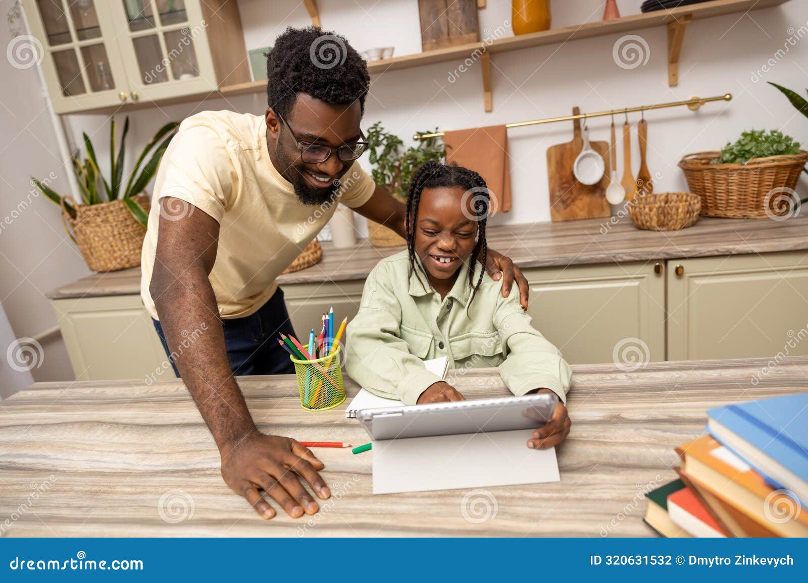 Multicultural Father and Little Girl Doing School Tasks Together Using ...