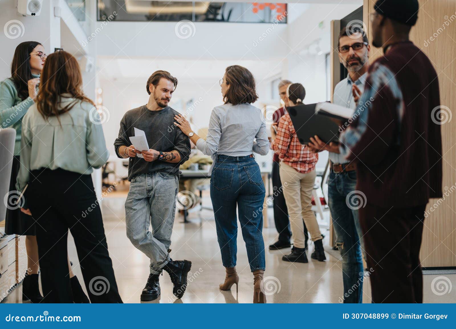 Multicultural Group of Colleagues Casually Interacting in an Open-plan ...