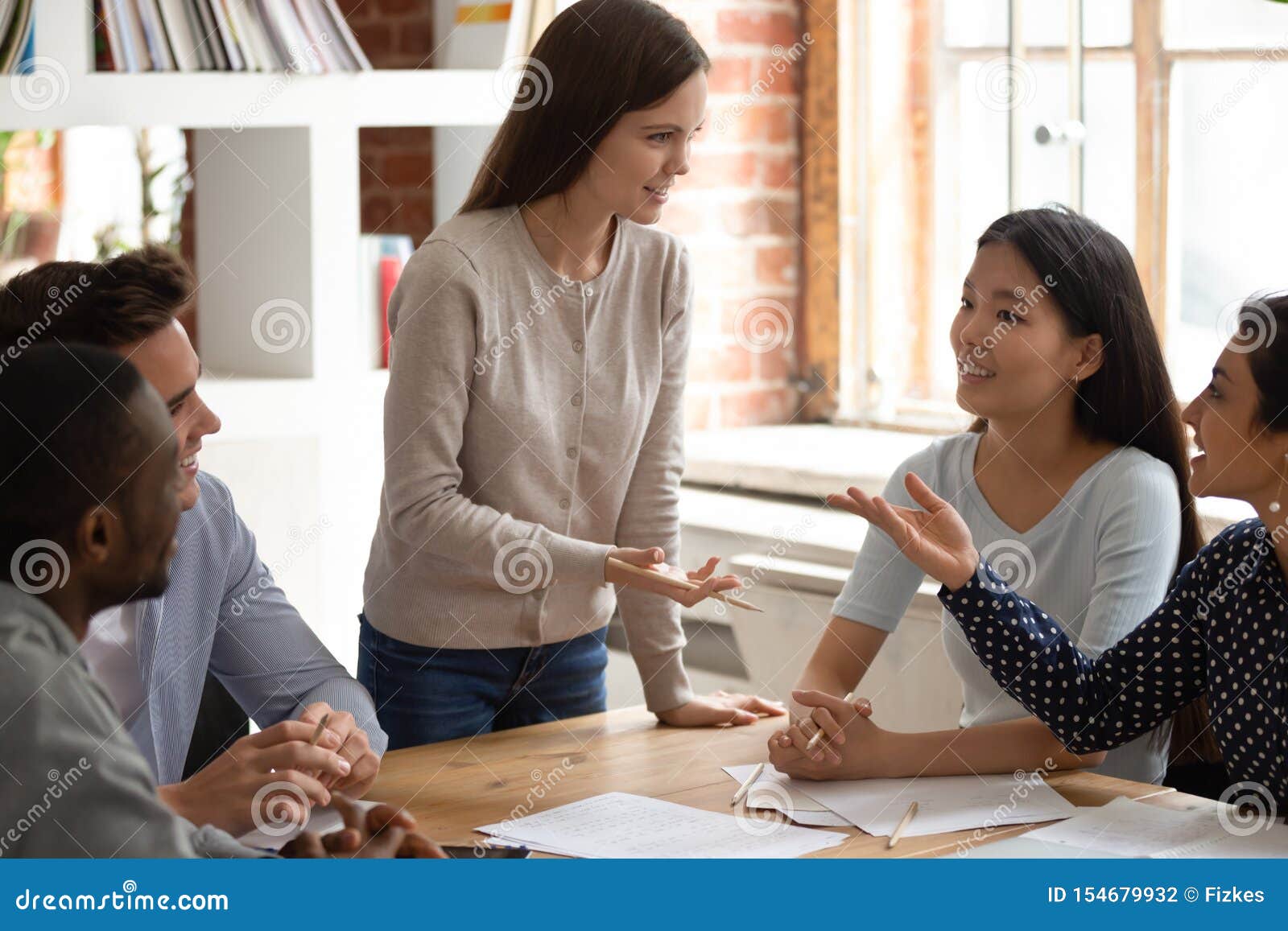 Multicultural Group Gather Discussing Project in Classroom Together ...
