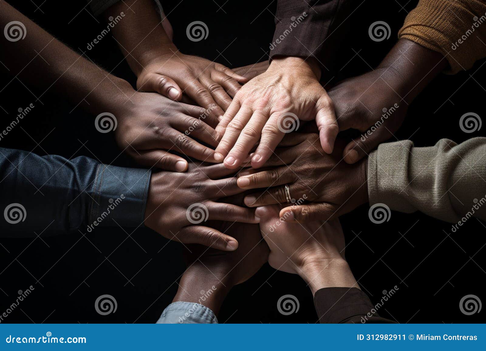Multicultural Group Placing Hands Together in a Symbol of Unity and ...