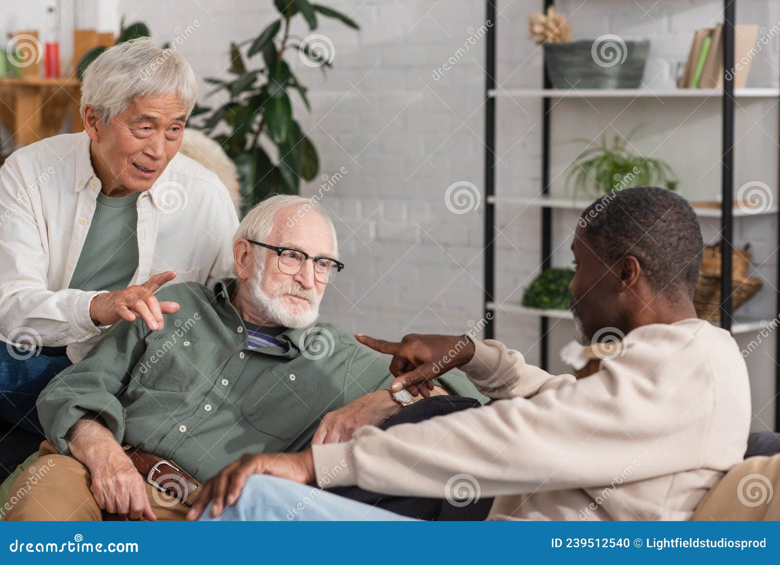 Multicultural Senior Friends Talking on Couch Stock Photo - Image of ...