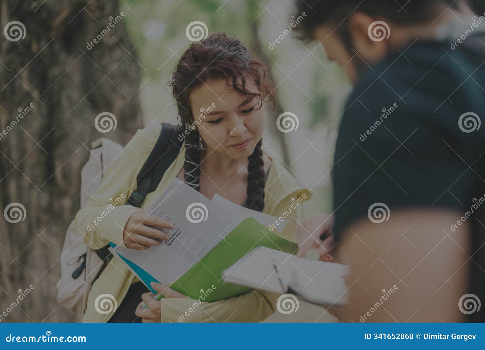 Multicultural Students Collaborating on Schoolwork in a Park Setting ...