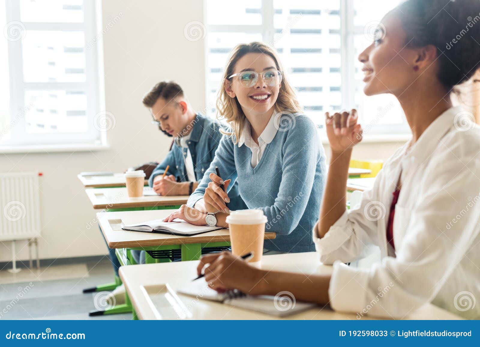 Multicultural Students with Notebooks Talking in College Stock Image ...