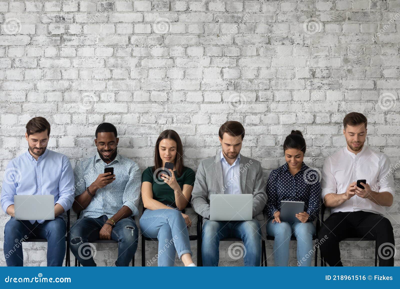 Multicultural Team of Gadget Users Sitting in Line, Using Laptops Stock ...