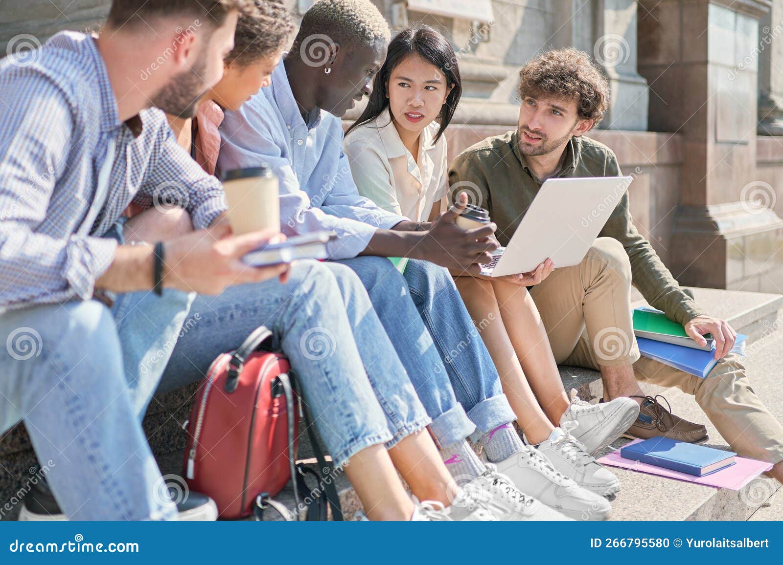 Multicultural Team of Students is Chatting on the Steps of the Campus ...