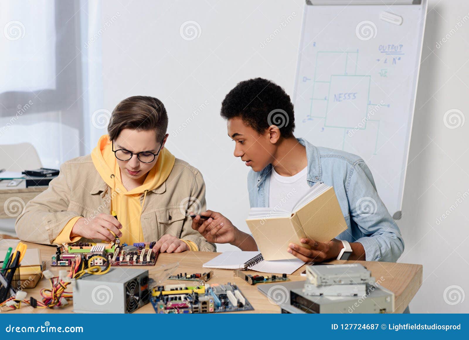 Multicultural Teen Boys Studying and Repairing Computer Motherboard ...