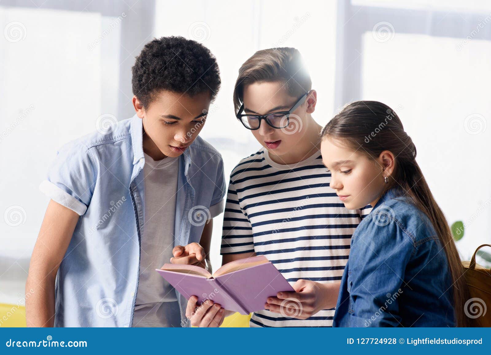 Multicultural Teenagers Looking at Book Stock Photo - Image of children ...
