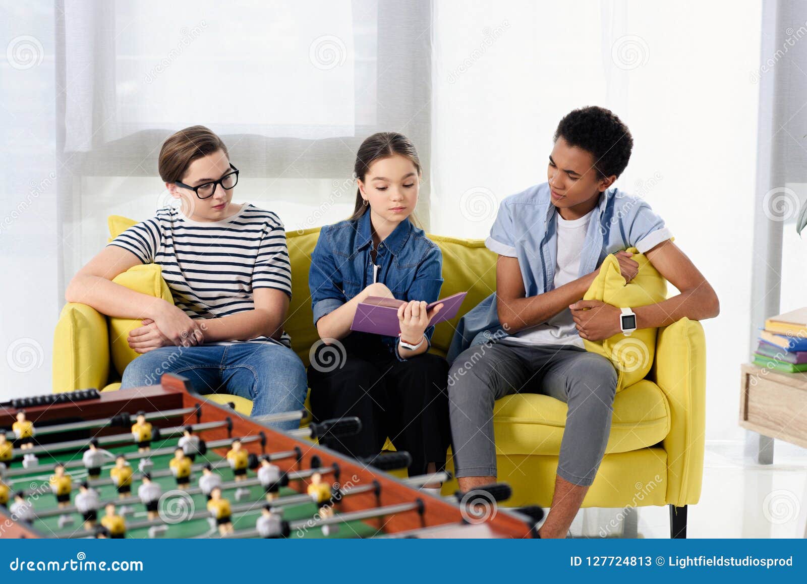 Multicultural Teenagers Reading Book on Sofa Stock Image - Image of ...