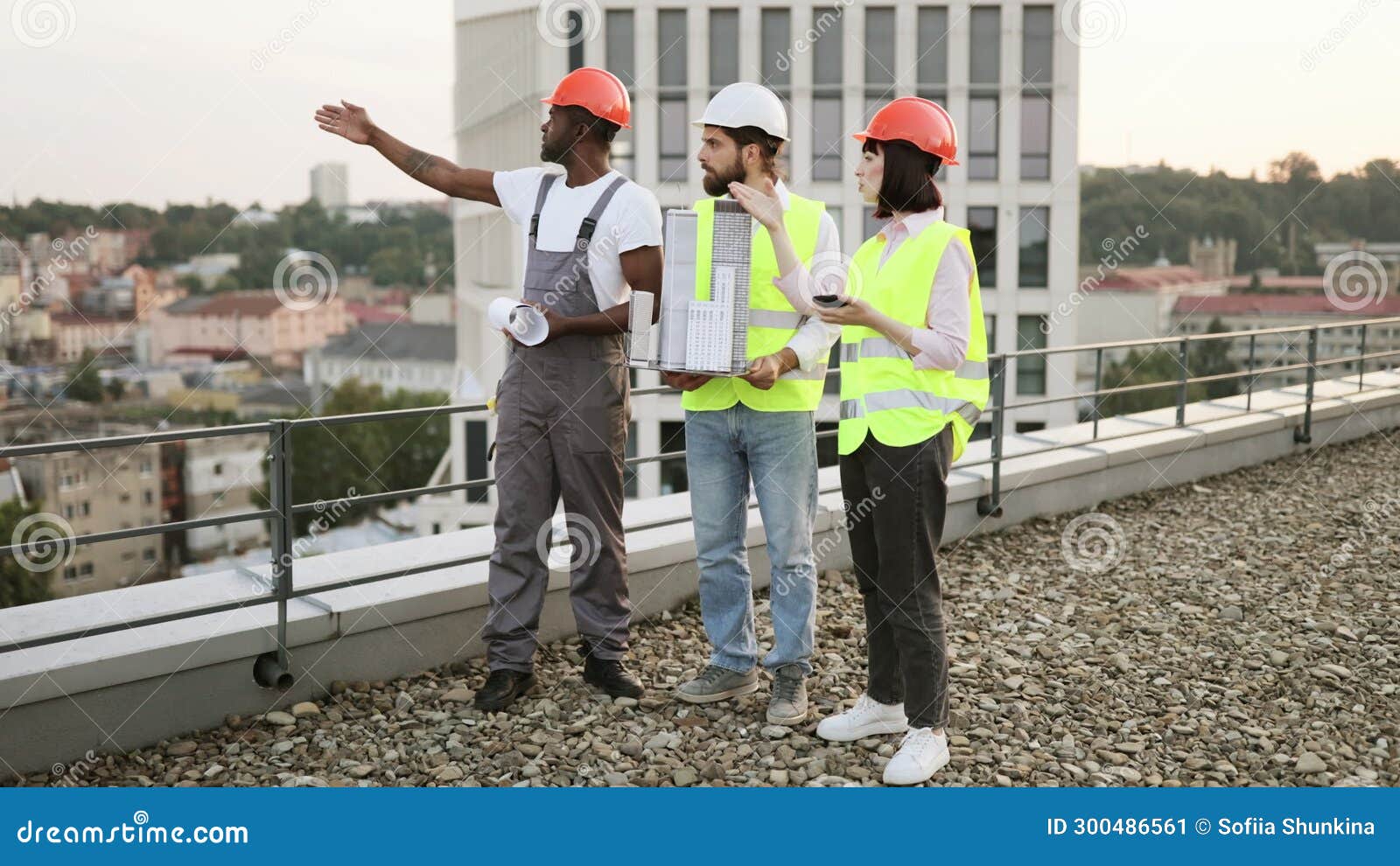 Multiethnic Architects Holding Copy of Building on Rooftop Stock Video ...