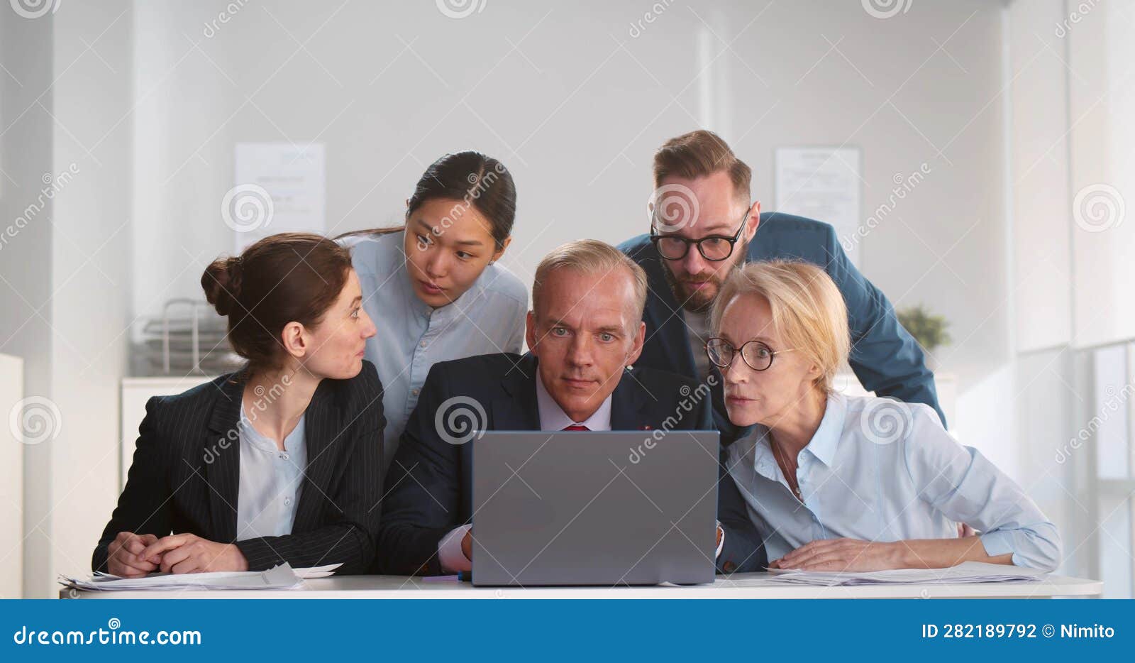 Multiethnic Business Team Looking at Laptop Screen while Working ...