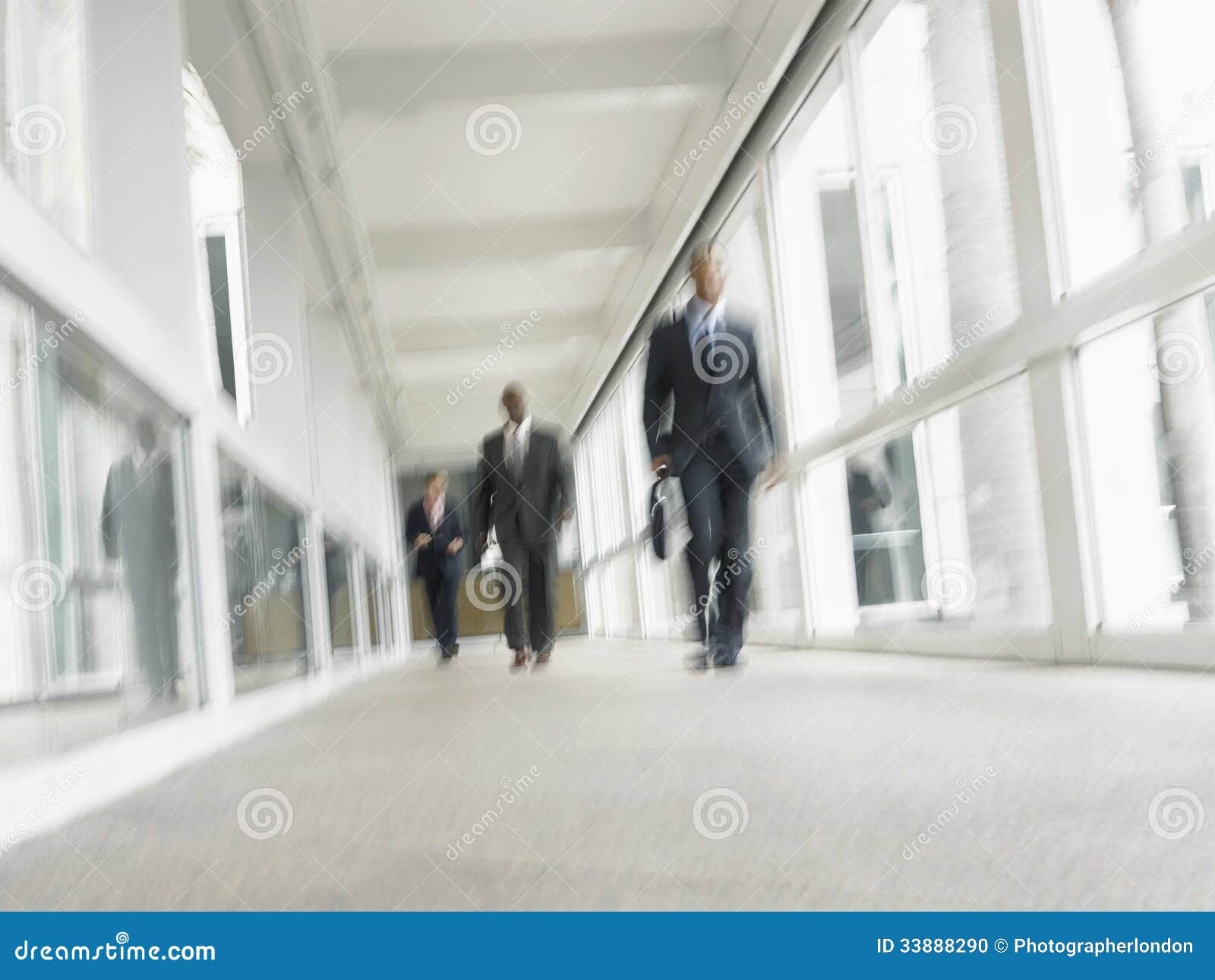 Businessmen Walking Down Ramp With Luggage In Parking Garage Stock ...