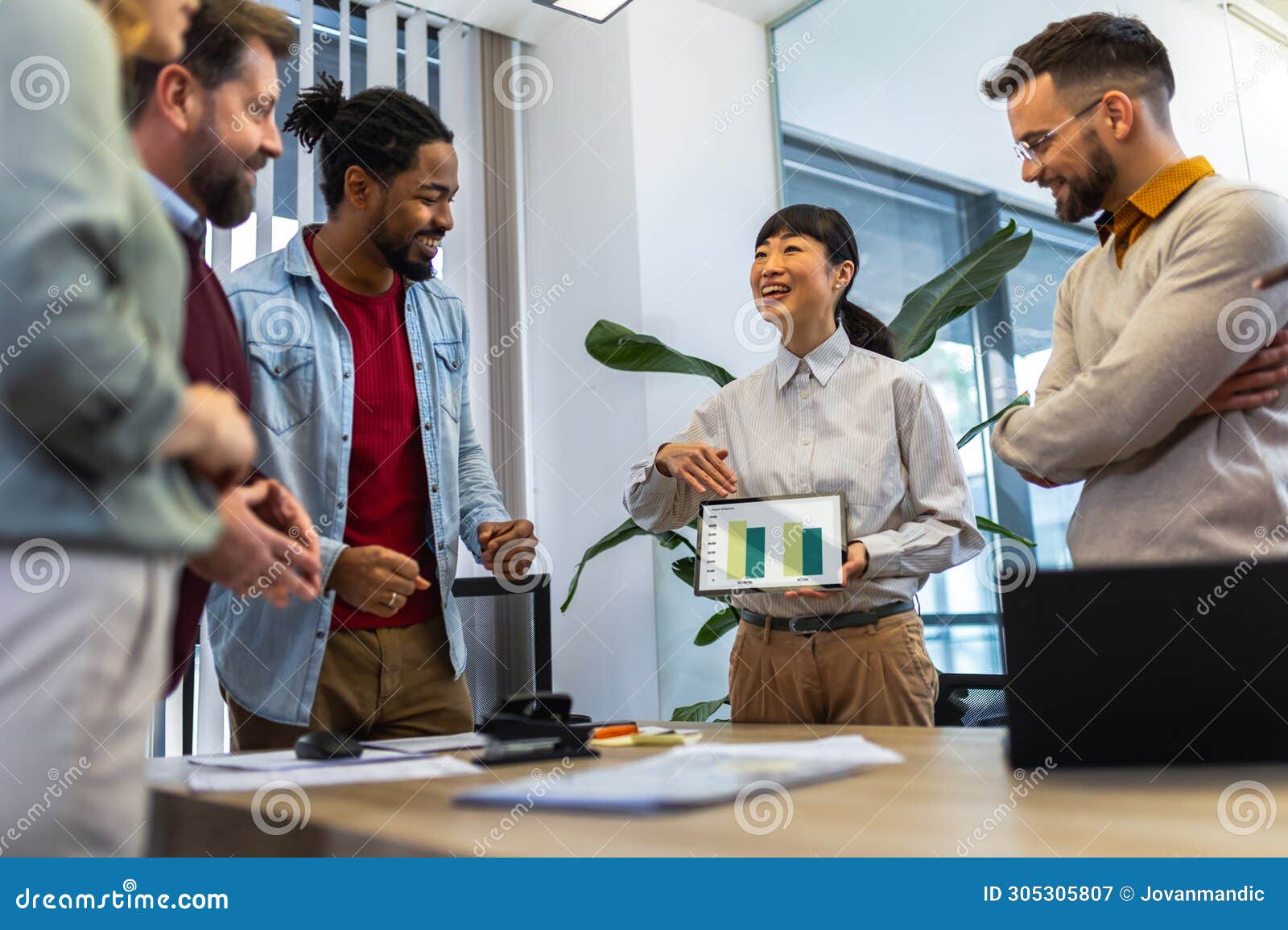 Multiethnic Colleagues Standing Together and Talking about Work in the ...