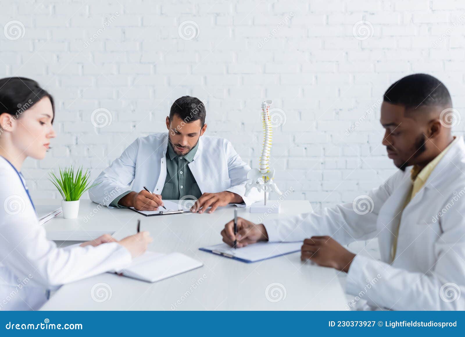 Multiethnic Doctors Working with Papers in Stock Image - Image of ...