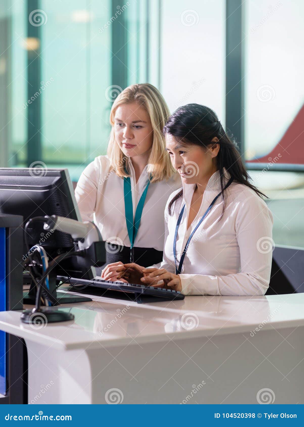 Female Ground Staff Using Computer at Reception in Airport Stock Photo ...